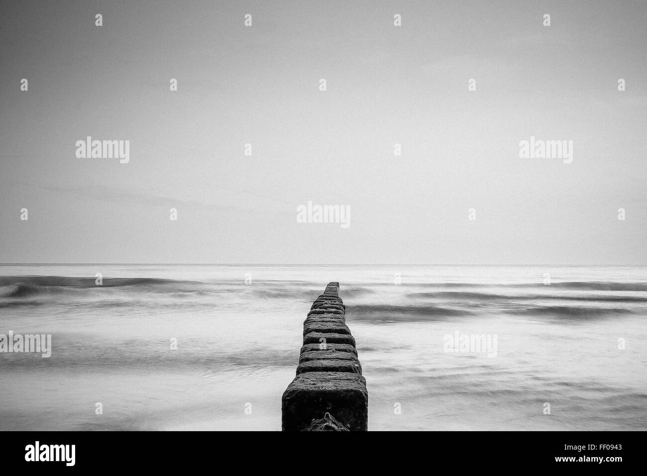A minimalist monochrome depiction of the ocean, showcasing black and ...