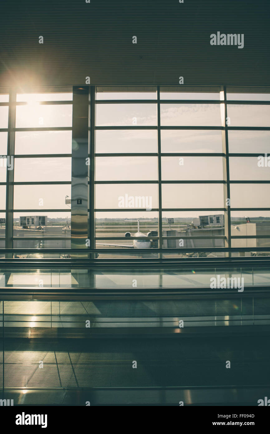 This image features the windows at an airport terminal, with geometric ...