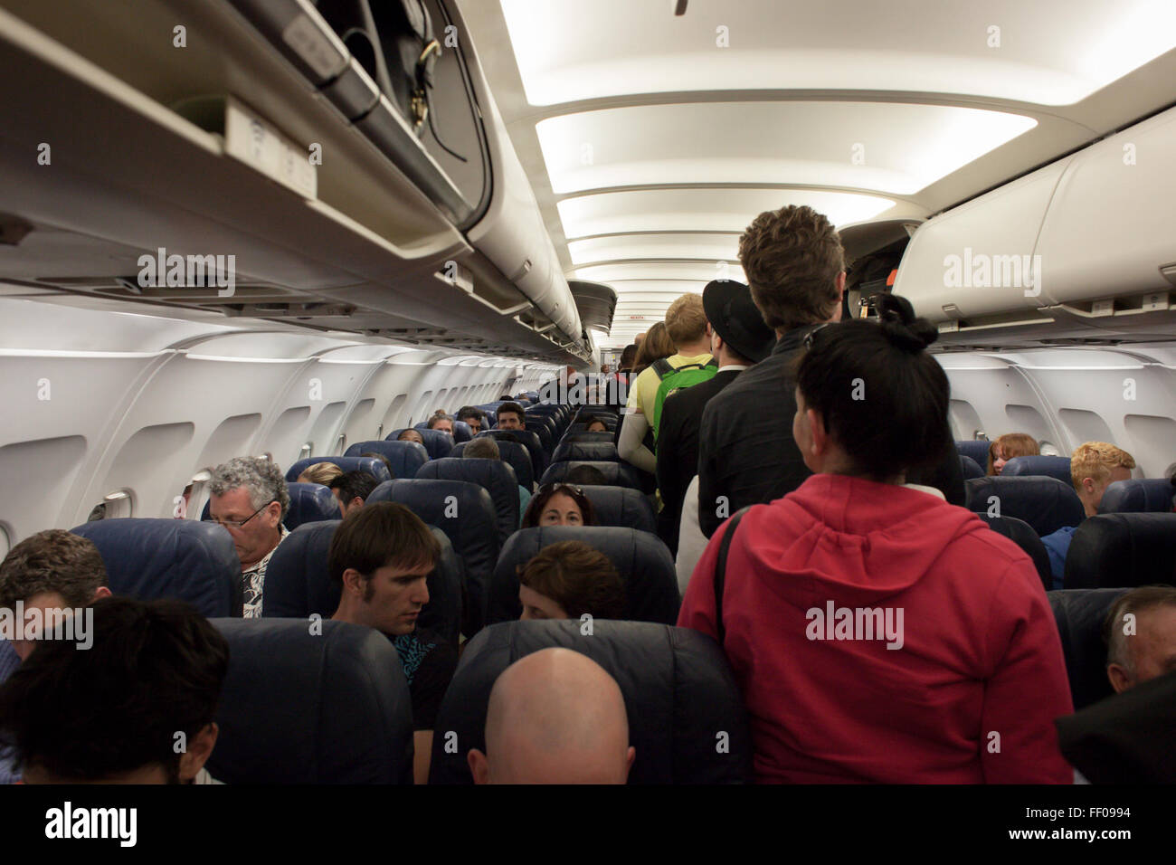 Passengers boarding an airplane at an airport, preparing for takeoff ...