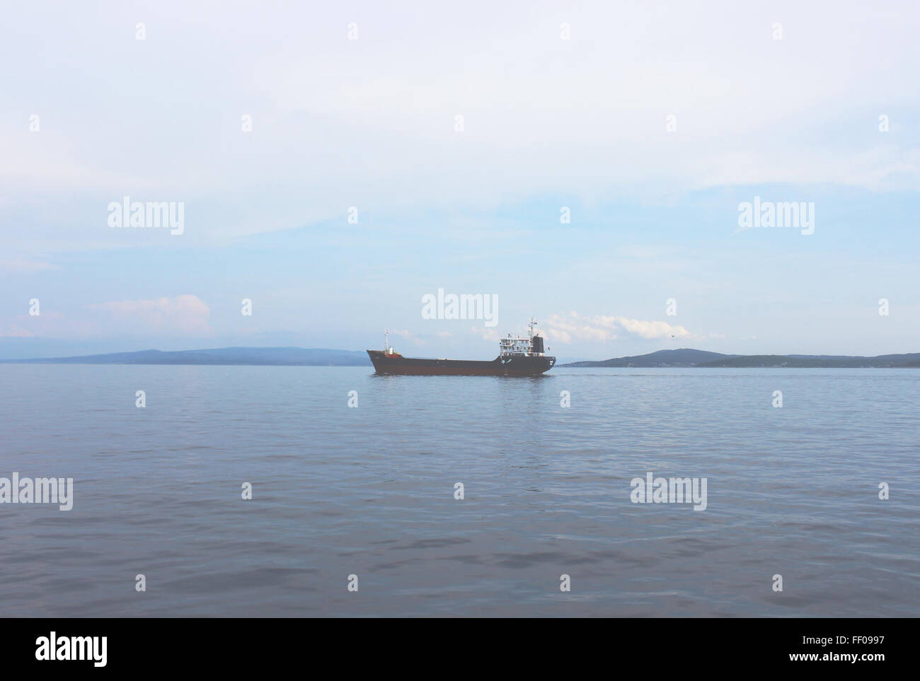 A ship is hauling through the ocean, navigating rough waters. The image ...