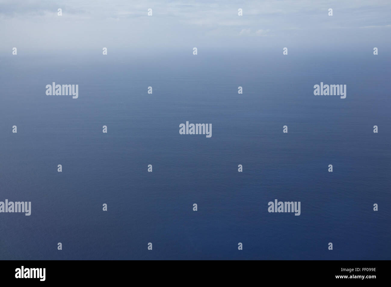 A view of blue ocean water extending to the horizon, with calm waves ...