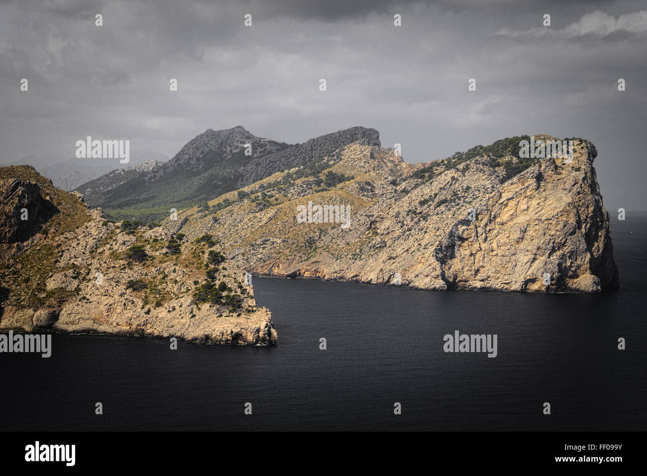 A dramatic scene where mountains meet the sea, with a cliffside ...