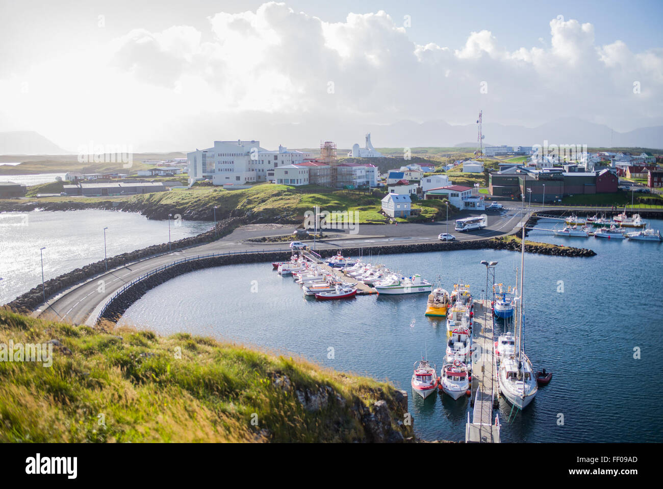 The docks of a small town are lined with ships, reflecting the town's ...