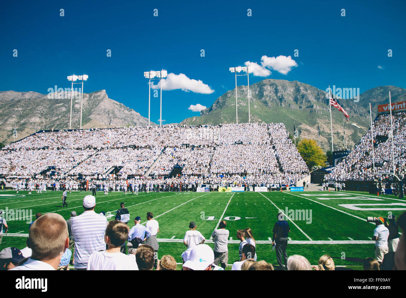 A crowded football stadium during a school game, with spectators ...