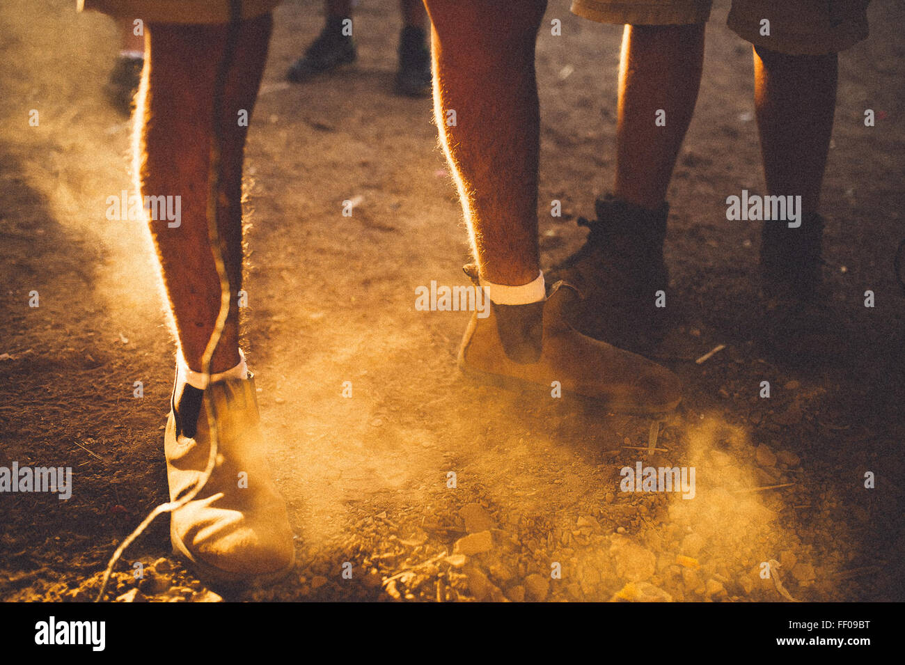 A person stands on a dusty, dry landscape, with dirt and dust visible ...