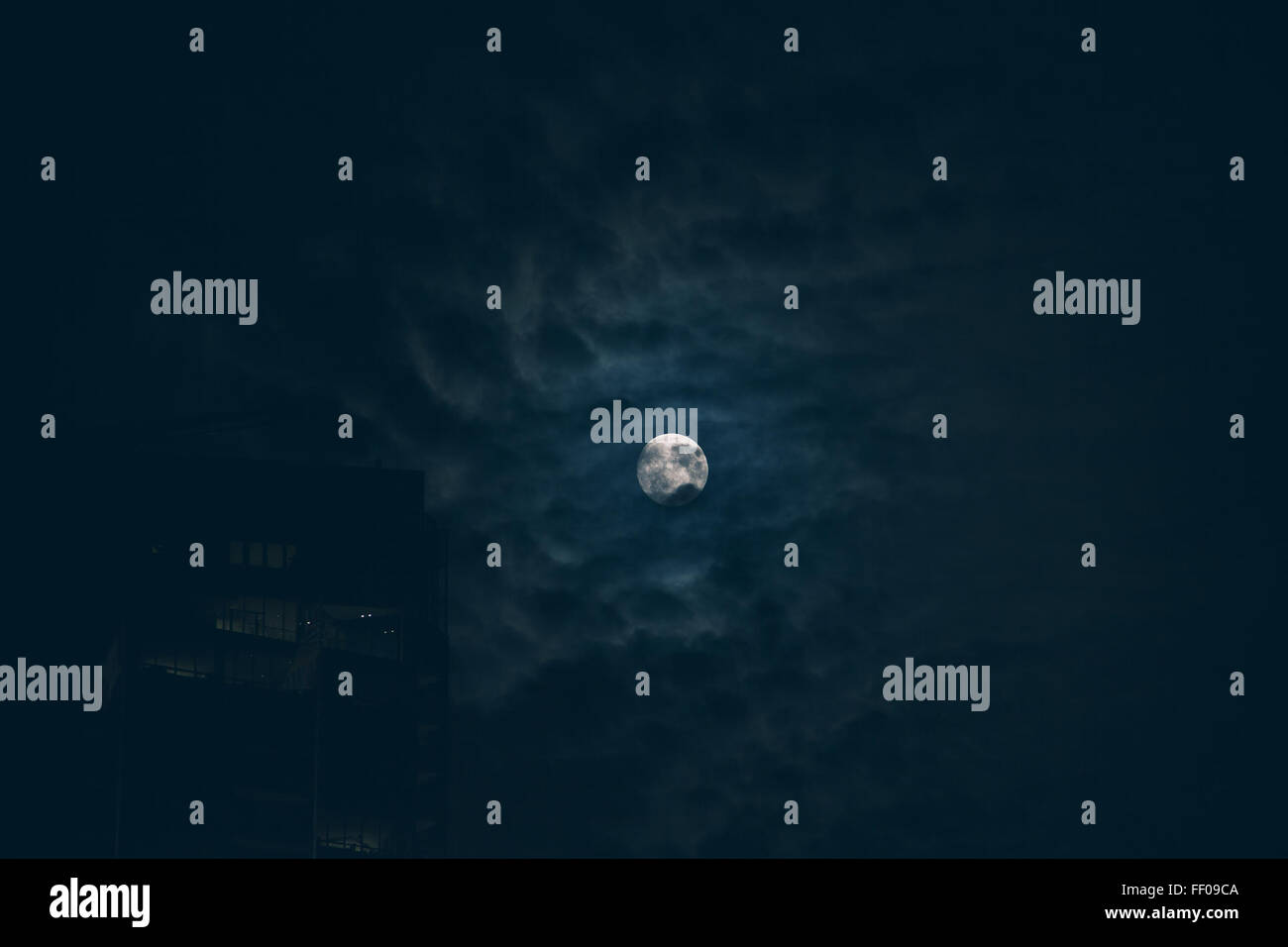 Moon behind clouds hi-res stock photography and images - Alamy