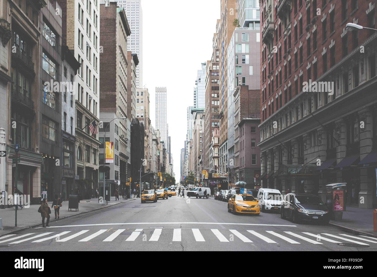 A crosswalk located near tall skyscrapers in an urban downtown area ...