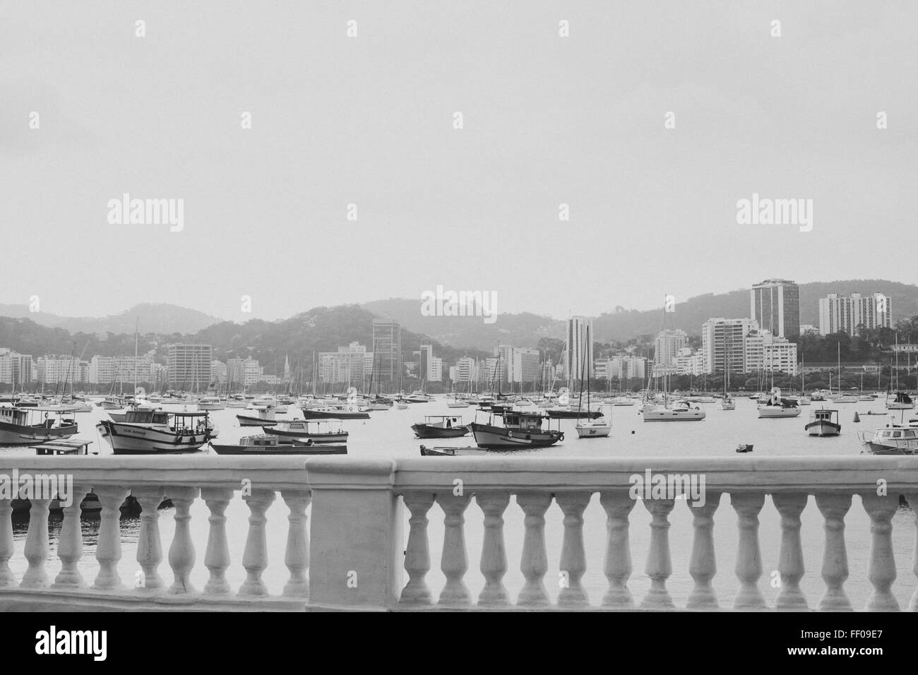 A busy harbor full of boats, including ships and smaller vessels, lined ...