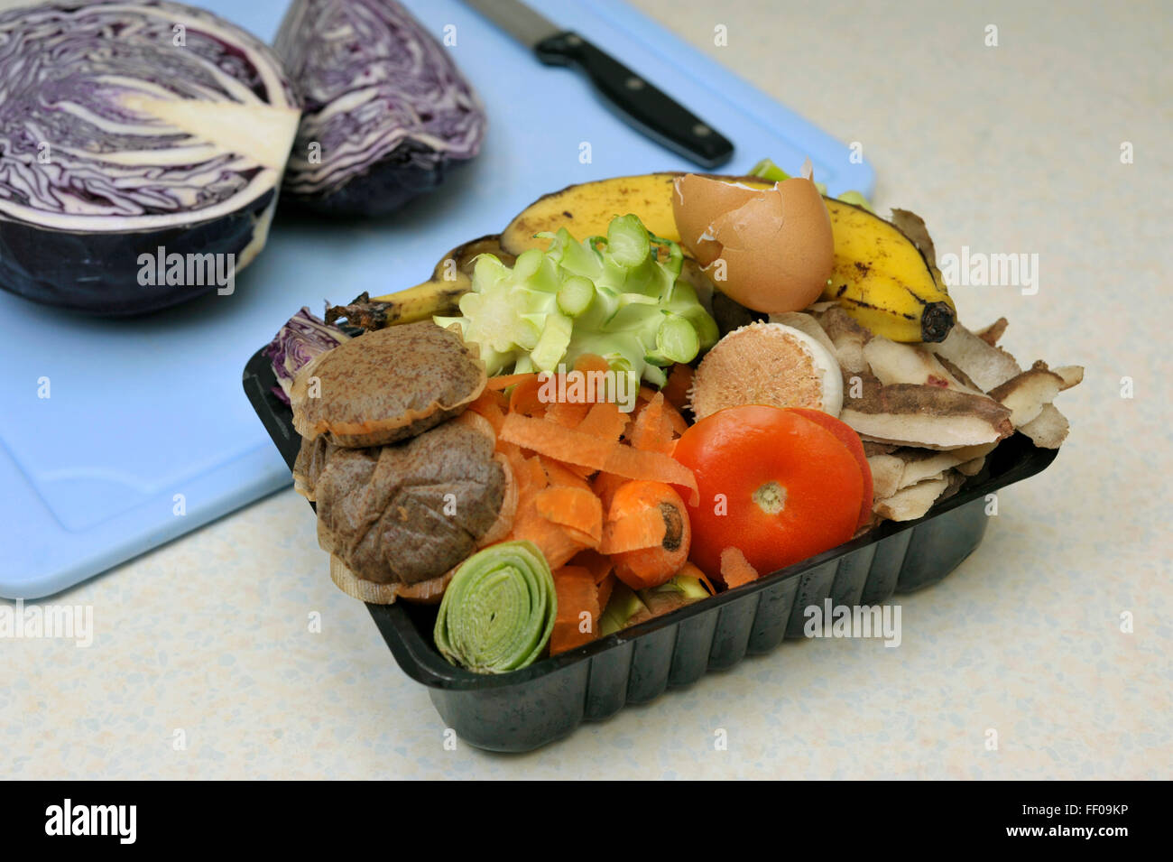 Kitchen raw food and vegetable waste collected in a reused container ...