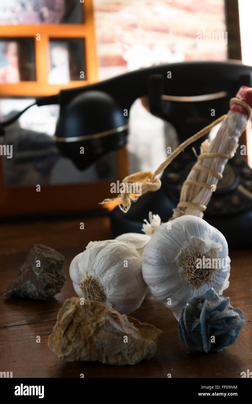 garlic string photographed with natural light on a wooden commode Stock ...