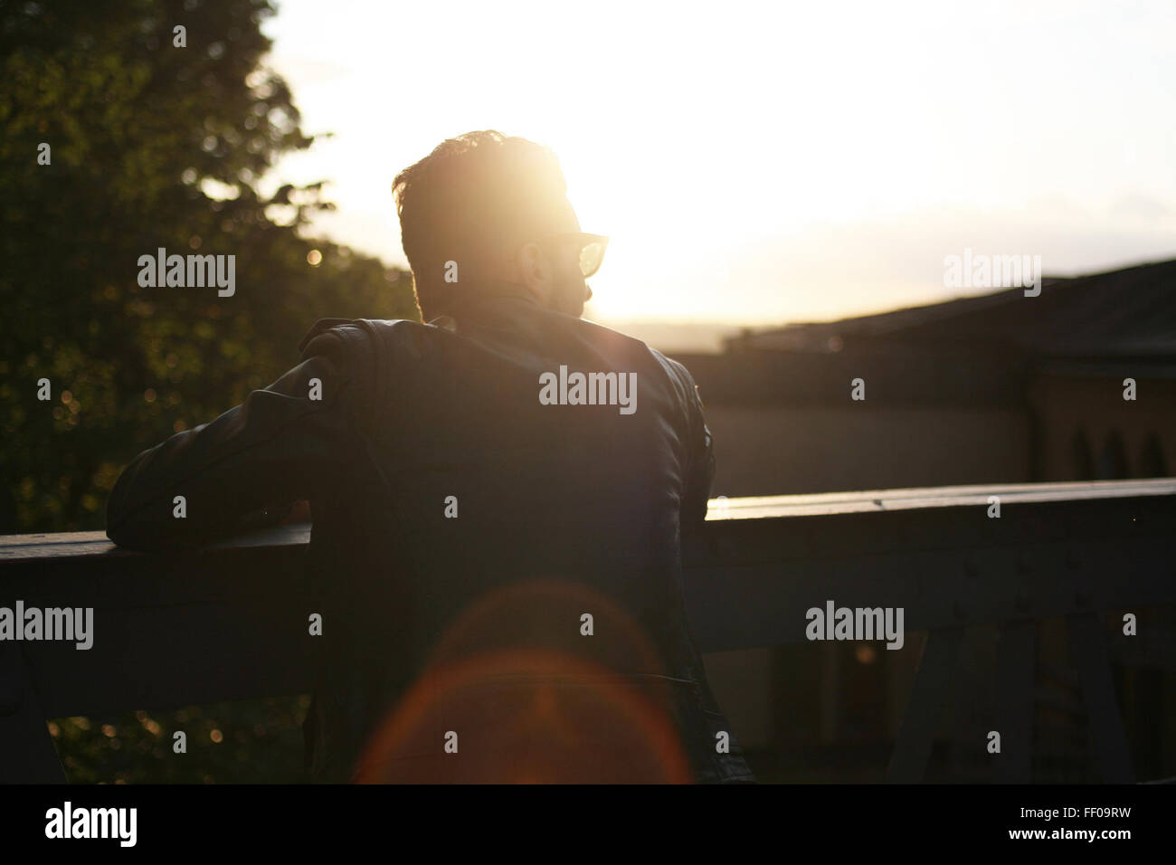 Silhouette of Person Leaning on Rail Silhouette of Person Leaning on ...