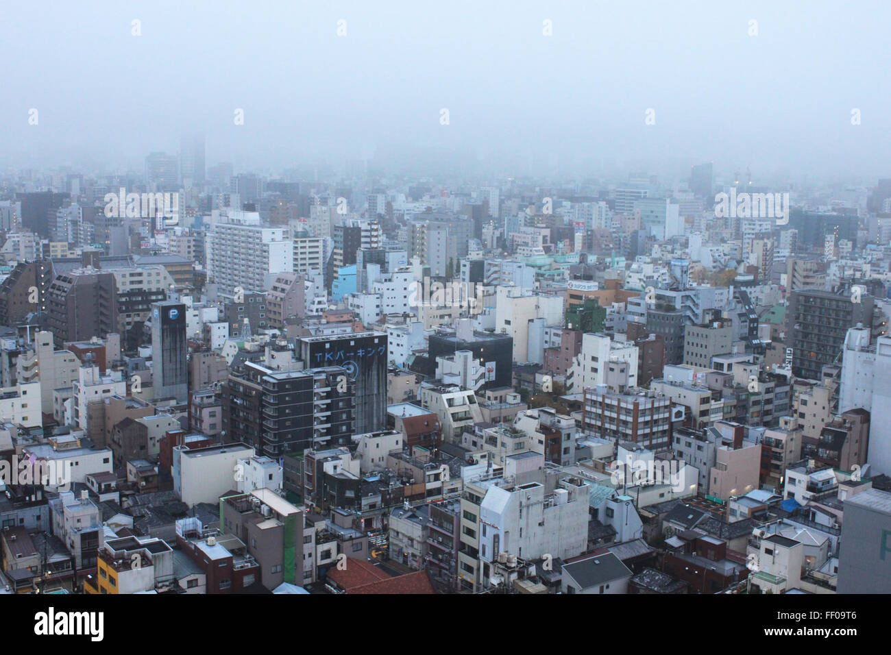 A cityscape shrouded in smog, where air pollution is visibly affecting ...