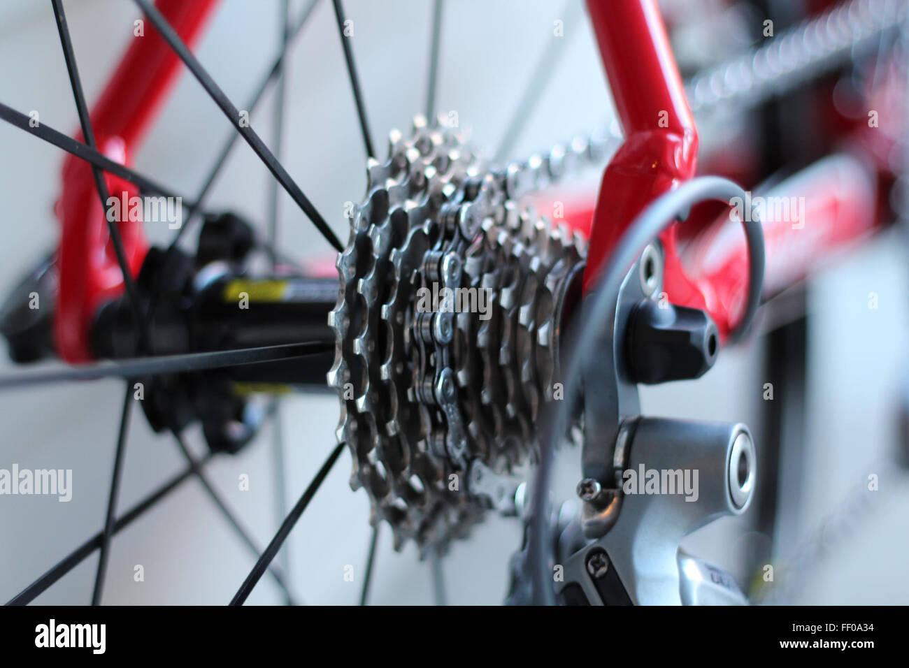 A close-up of bicycle gears and spokes, highlighting the geometric ...