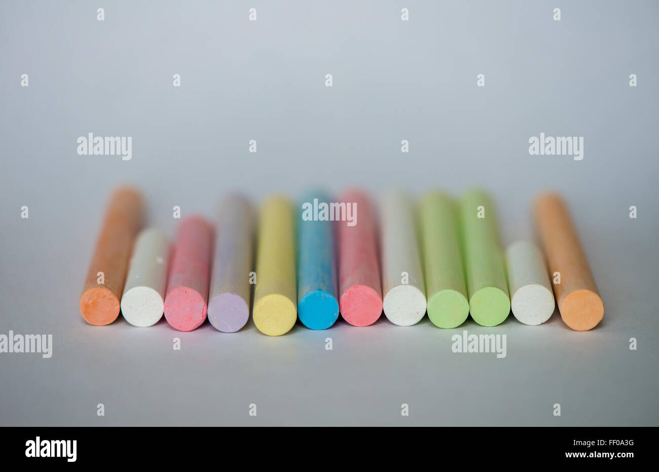 A set of colorful pastel chalks, arranged in a variety of hues. The ...