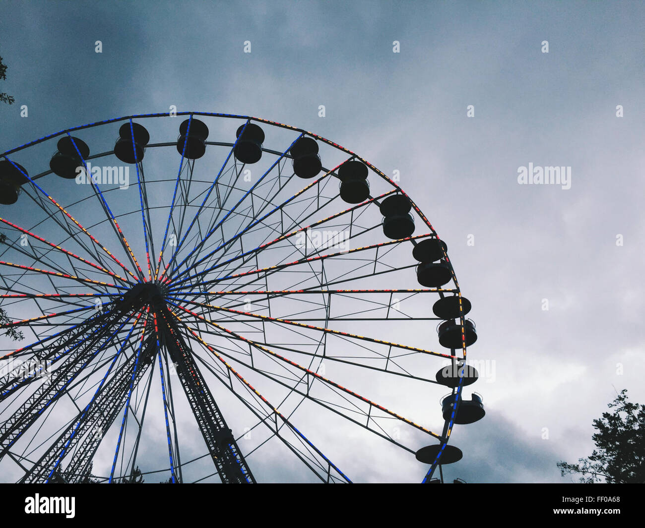 A Ferris wheel standing tall at an amusement park. The circular ride, a ...