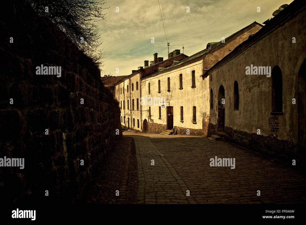 A cobbled alleyway with uneven stone paving, nestled between buildings ...