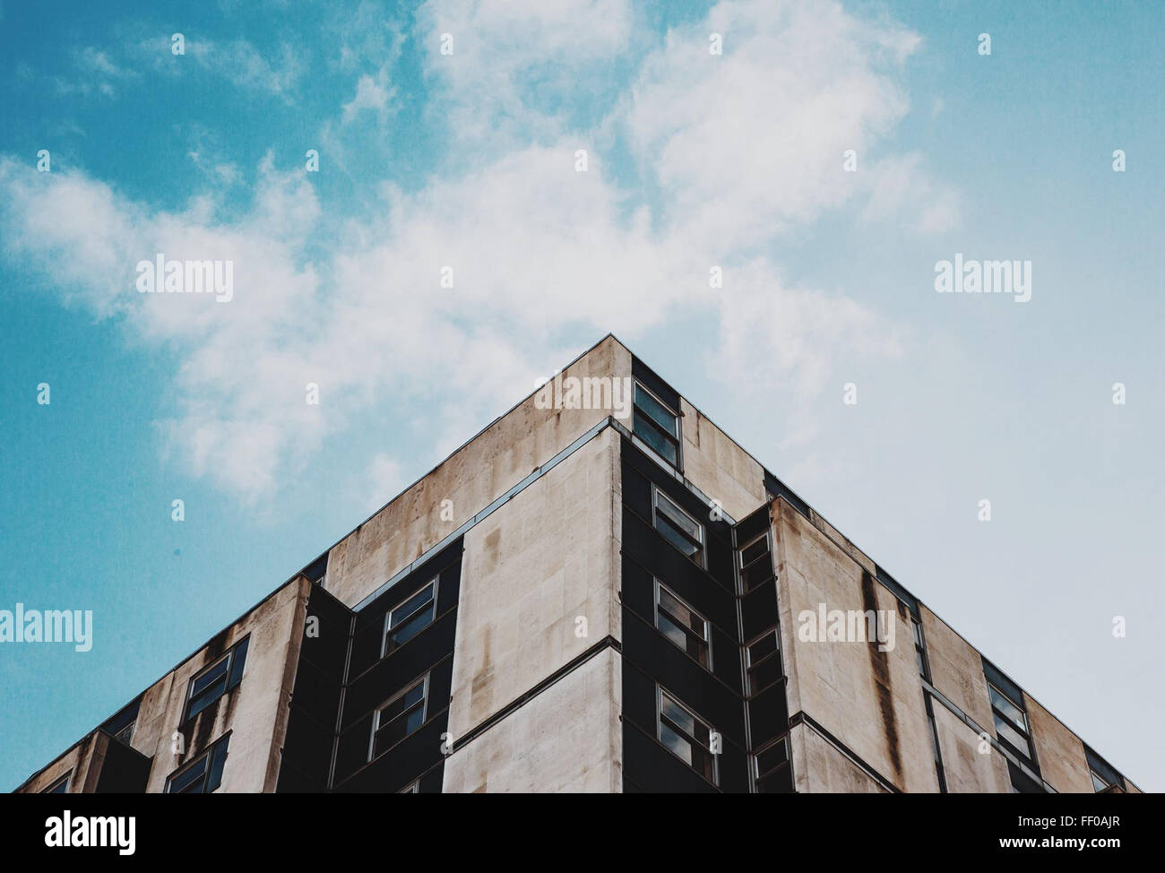 A geometric view of a building corner under a clear blue sky ...