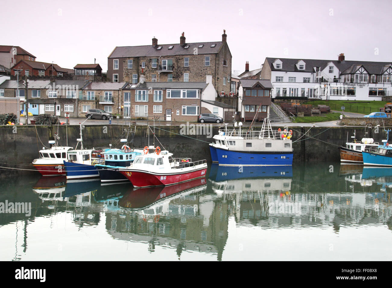 Fishing boats seahouses harbour northumberland hi-res stock photography ...