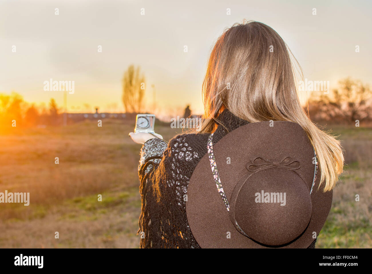 Explorer girl with a compass Stock Photo - Alamy