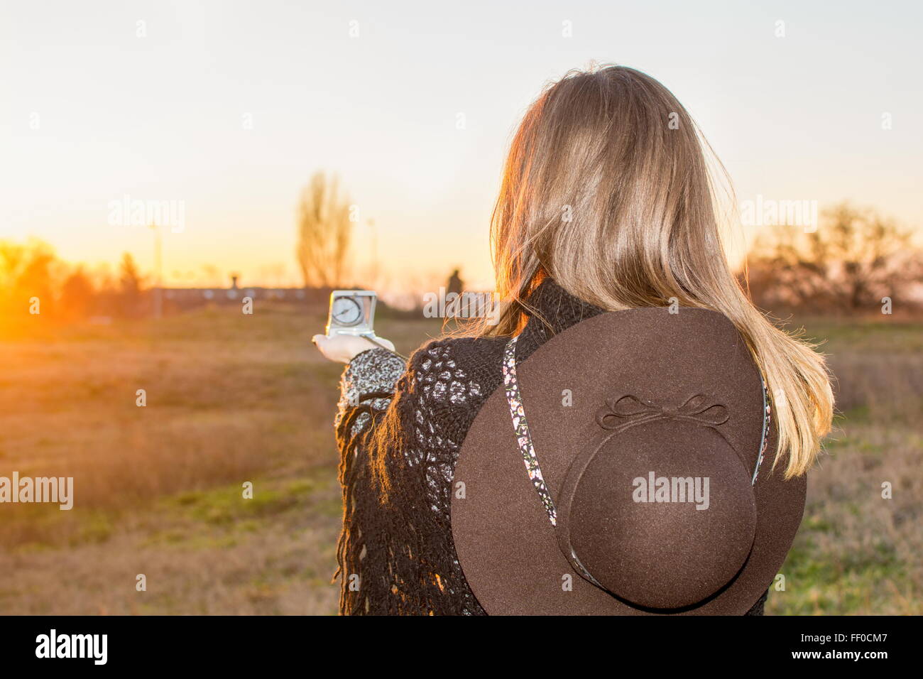 Explorer girl with a compass Stock Photo - Alamy