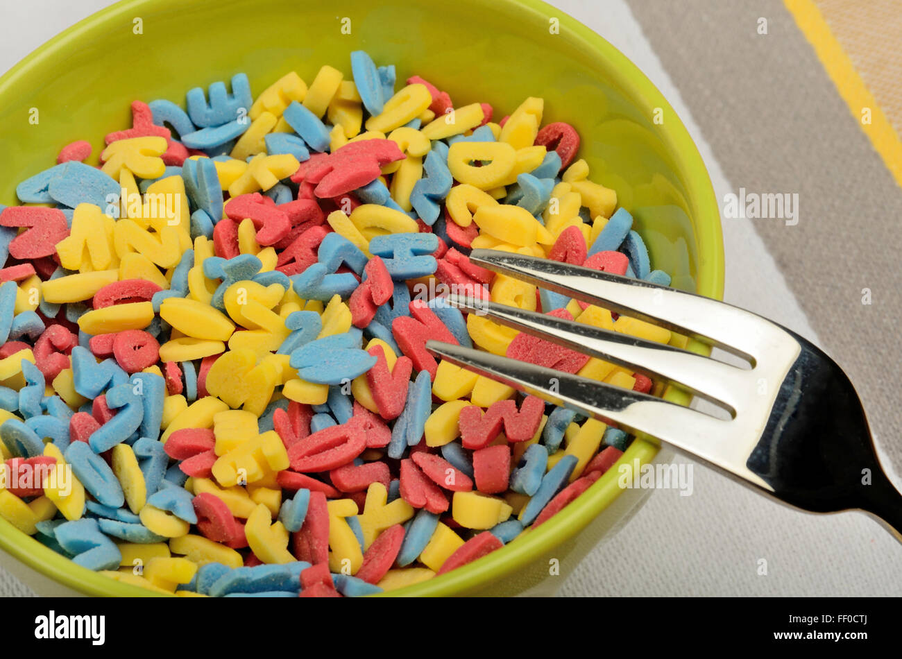 Bowl with colorful sugar letters on table Stock Photo - Alamy