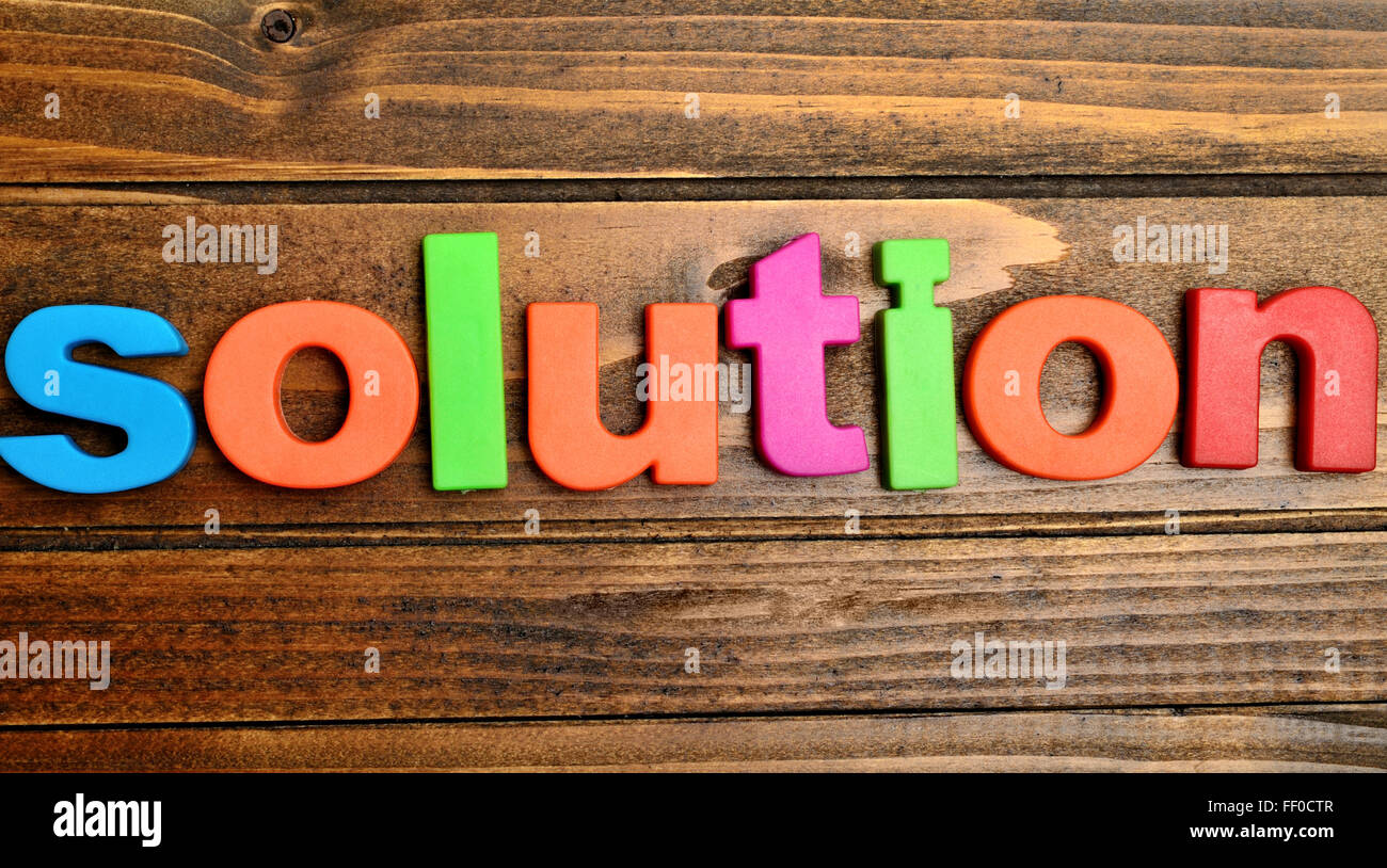 Solution word on wooden table Stock Photo - Alamy