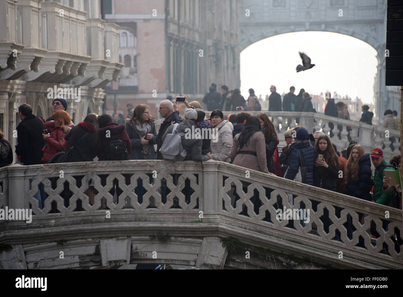 Busy scene on a bridge in Venice during carnival Stock Photo - Alamy