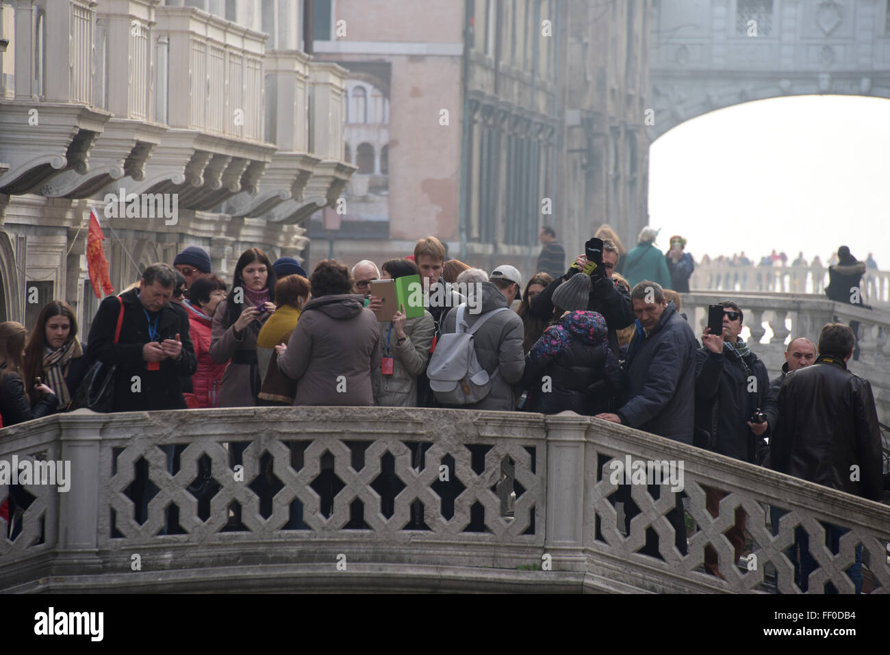 Busy scene on a bridge in Venice during carnival Stock Photo - Alamy