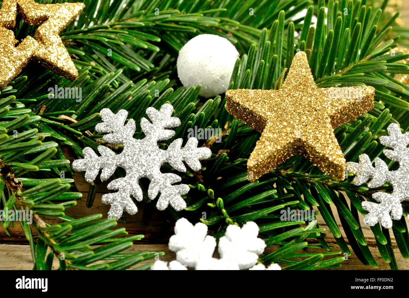 Tree branch decoration with shiny star and snowflake on table Stock ...