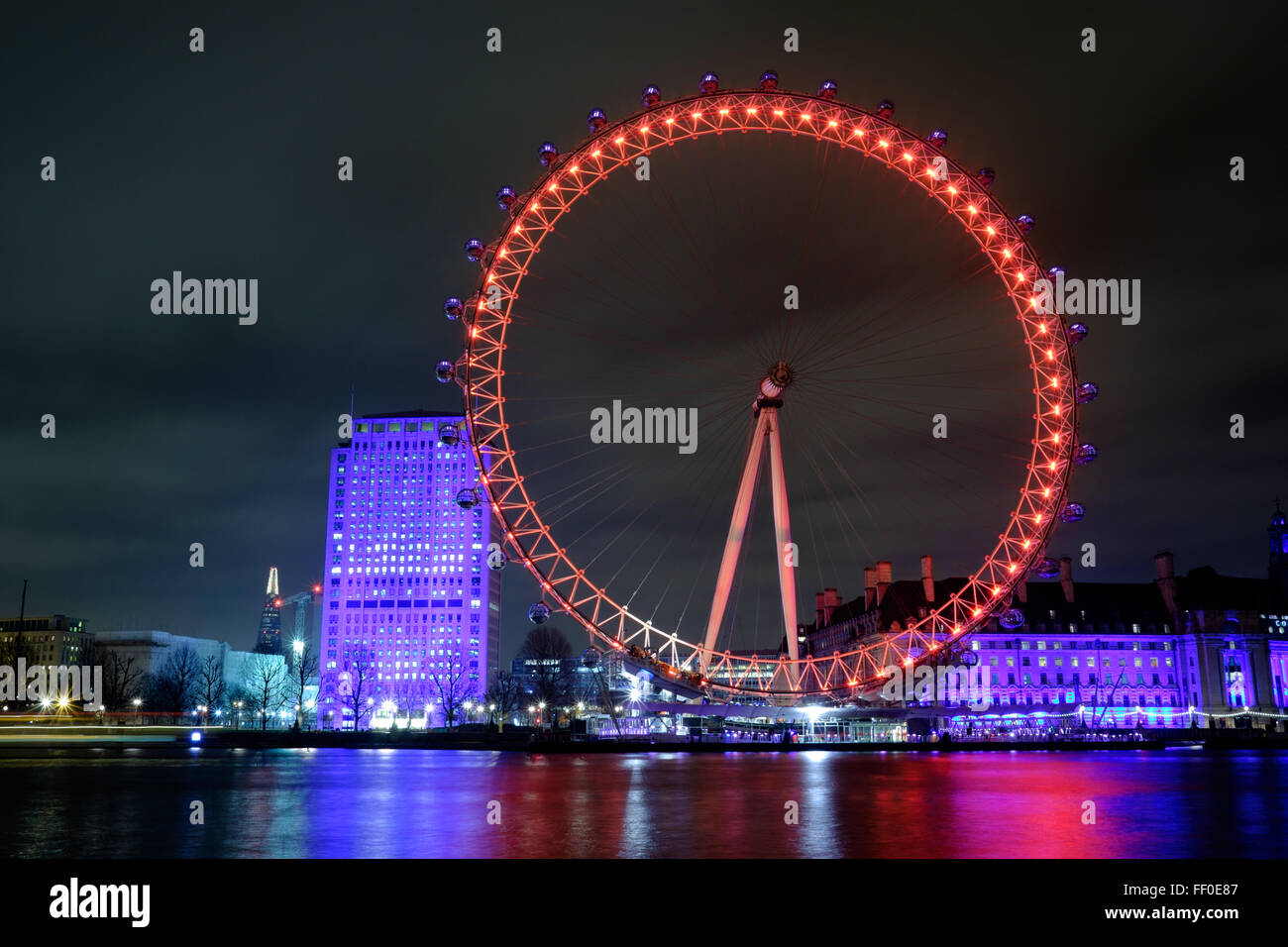 A night image of the London Eye overlooking the River Thames from ...