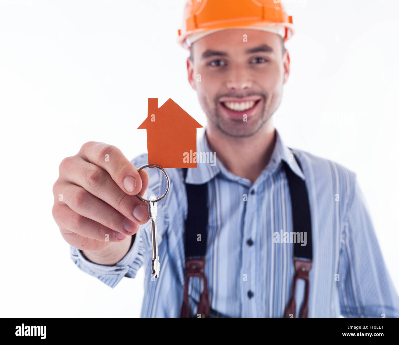 A builder man holding a key and a paper house Stock Photo - Alamy
