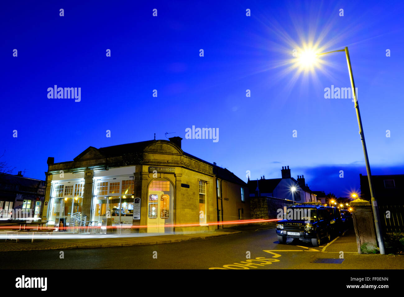 A night photograph of The Classroom Restaurant with a streetlight and ...