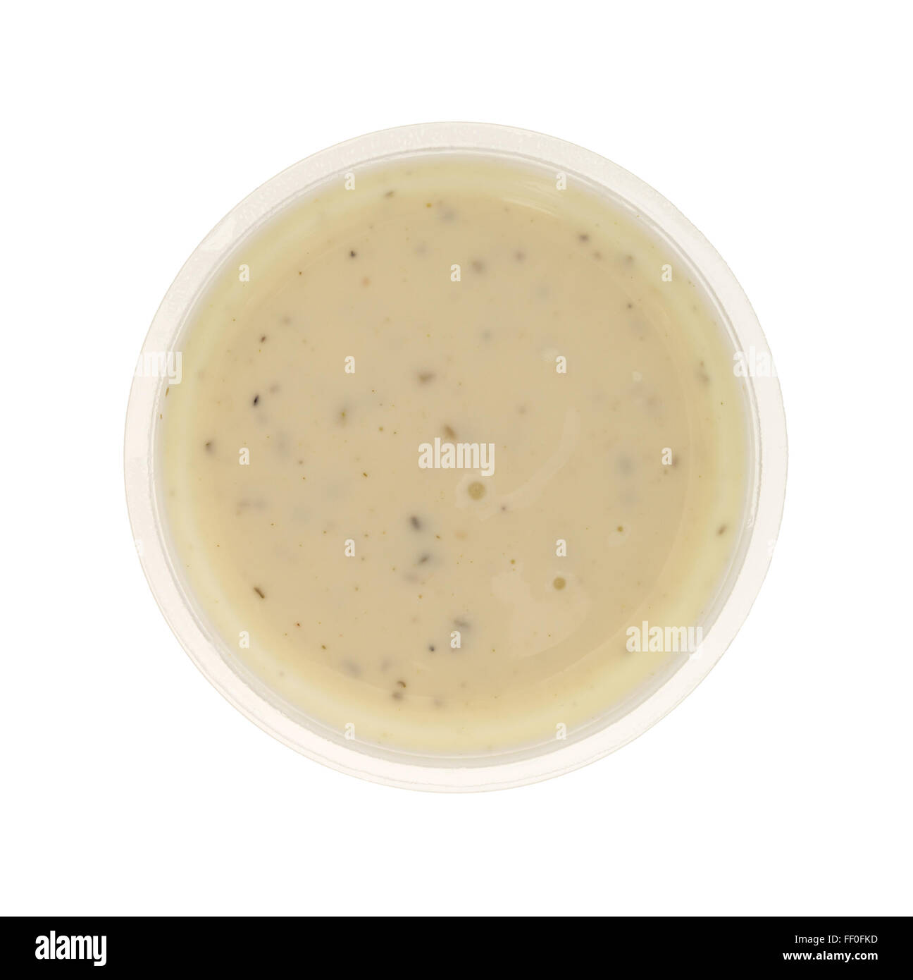 Top view of a small plastic container of ranch dressing isolated on a ...