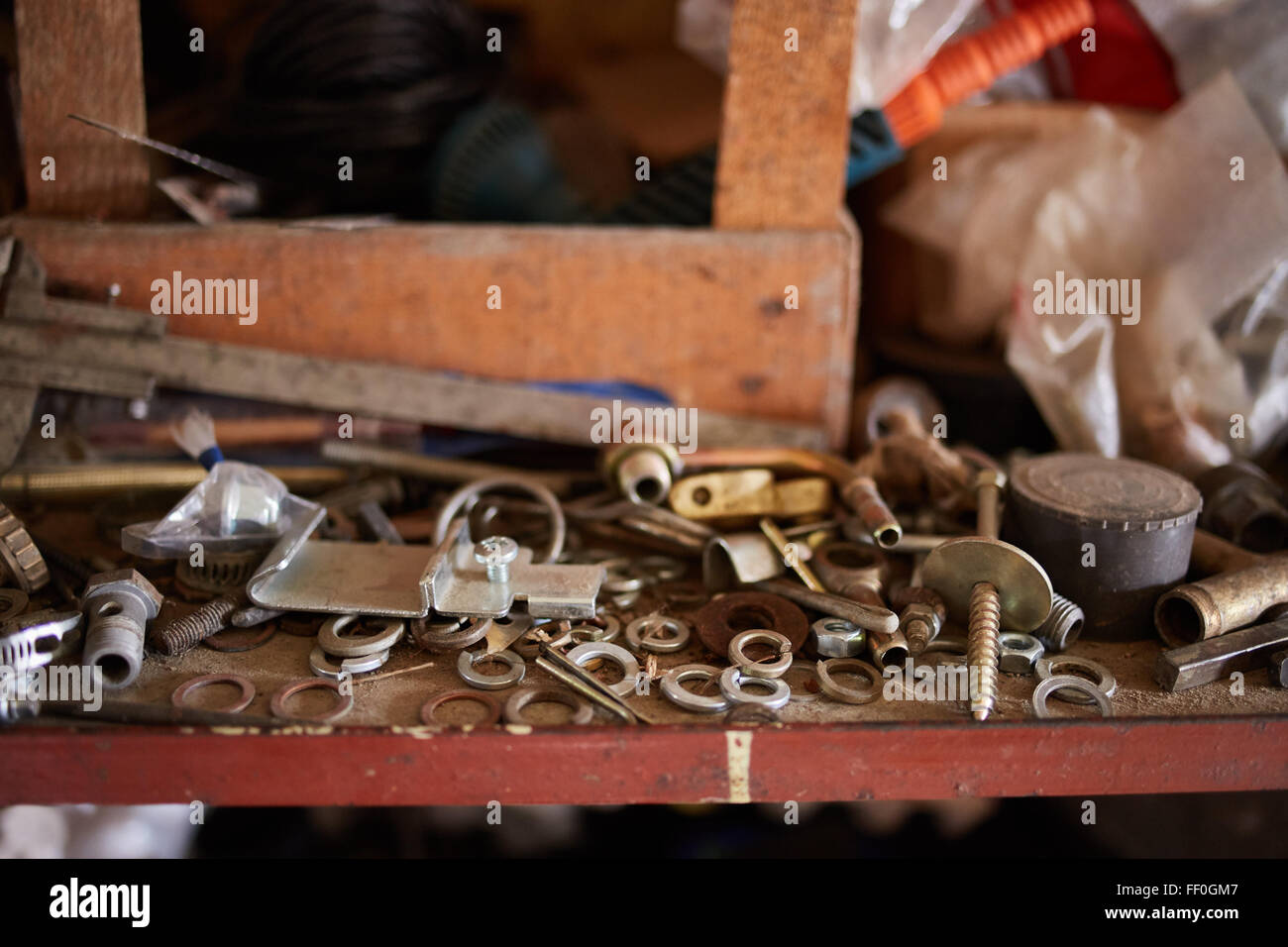 Rusty nuts and bolts in disarray on a shelf Stock Photo - Alamy