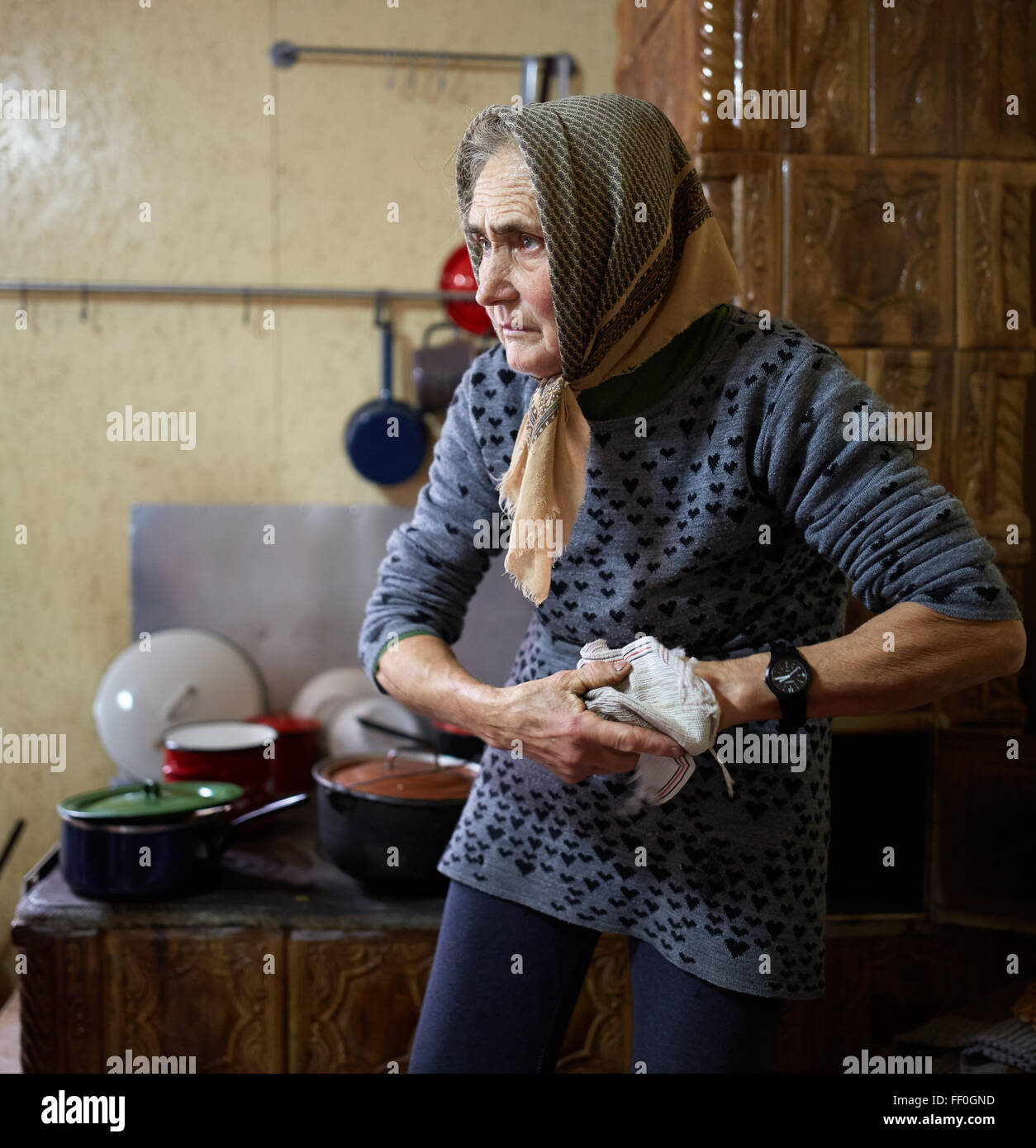 Portrait of an old peasant woman indoor by the heater Stock Photo - Alamy
