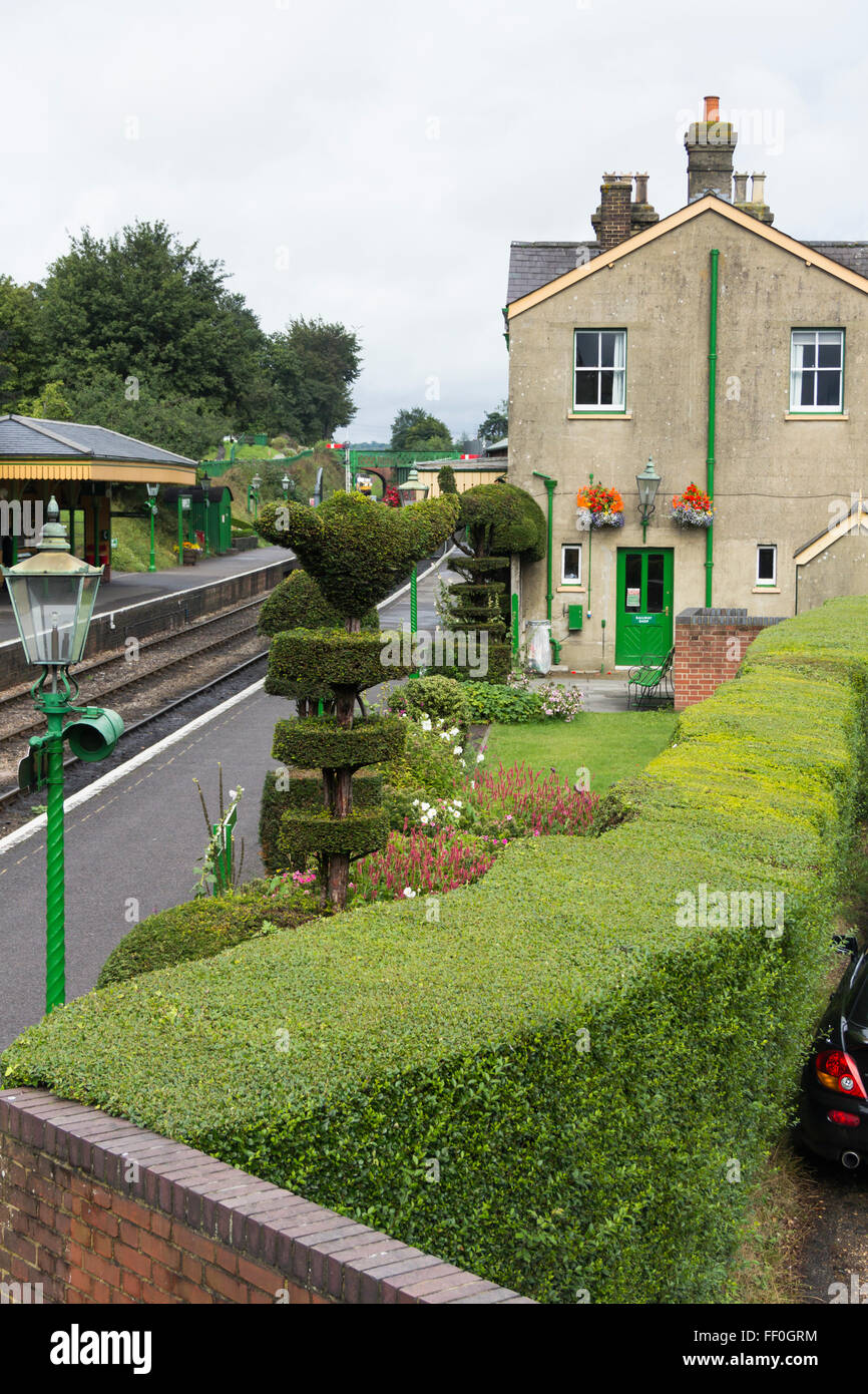 Well trimmed hedges, gardens and Yew tree topiary at Ropley station on ...
