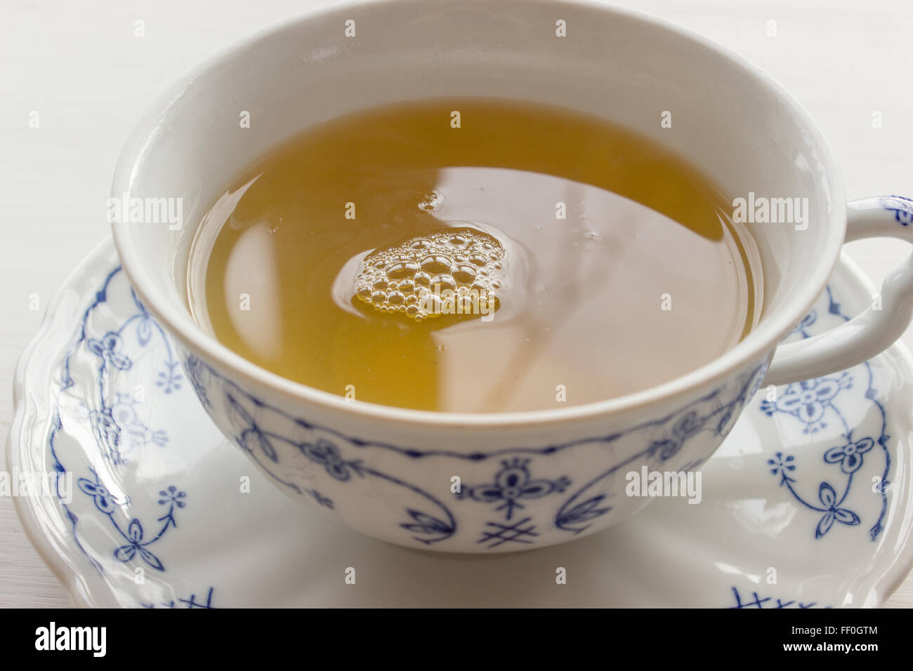 white teacup with delicate blue pattern on a table Stock Photo - Alamy