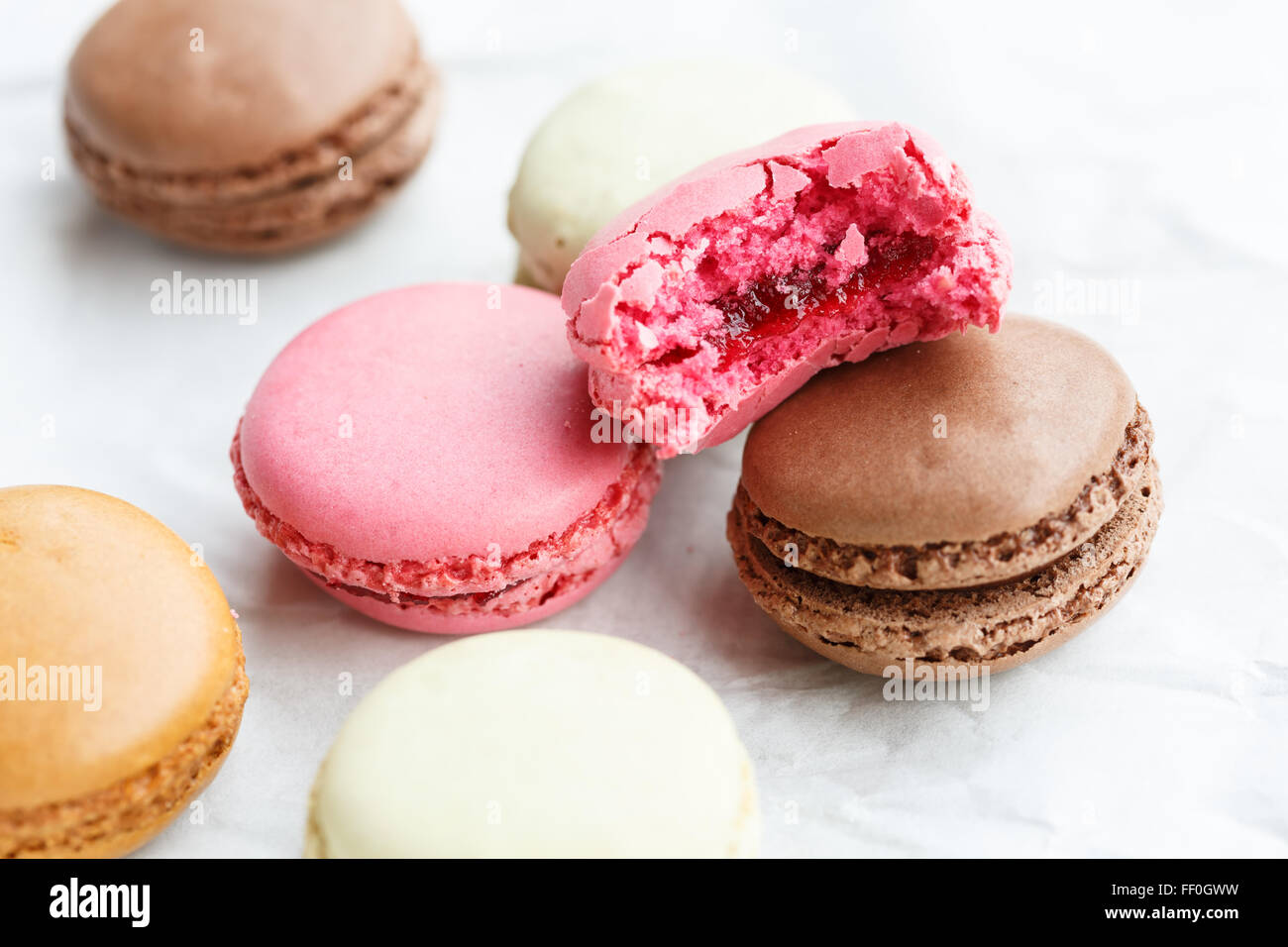 Macaron (small French cake), one partly eaten Stock Photo - Alamy