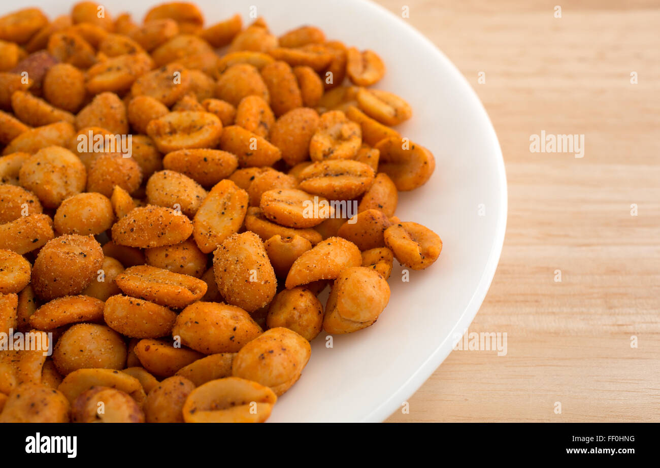 Close view of a portion of hot and spicy peanuts isolated on a white ...