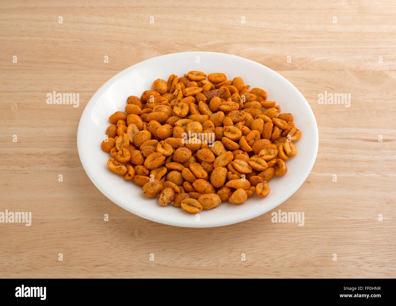 Side view of a portion of hot and spicy peanuts isolated on a white ...