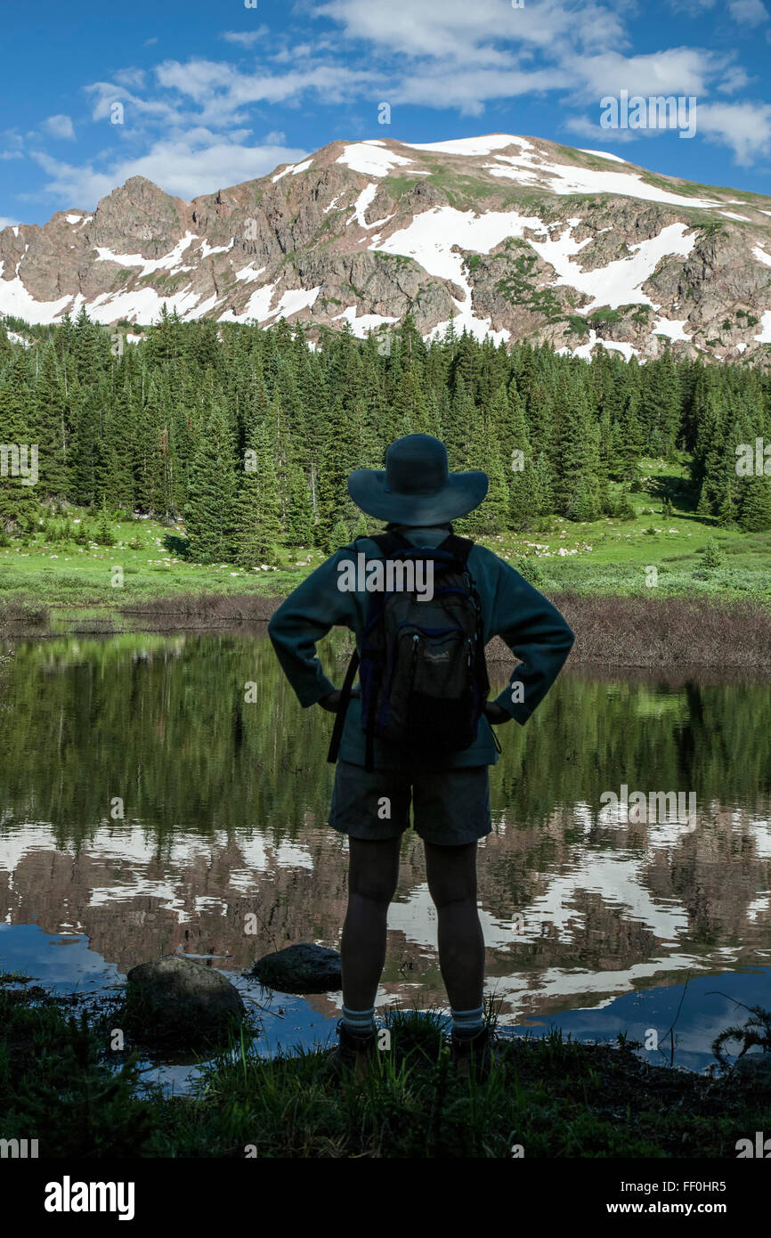 Mountain reflected on beaver pond and hiker silhouette, Meadow Creek ...