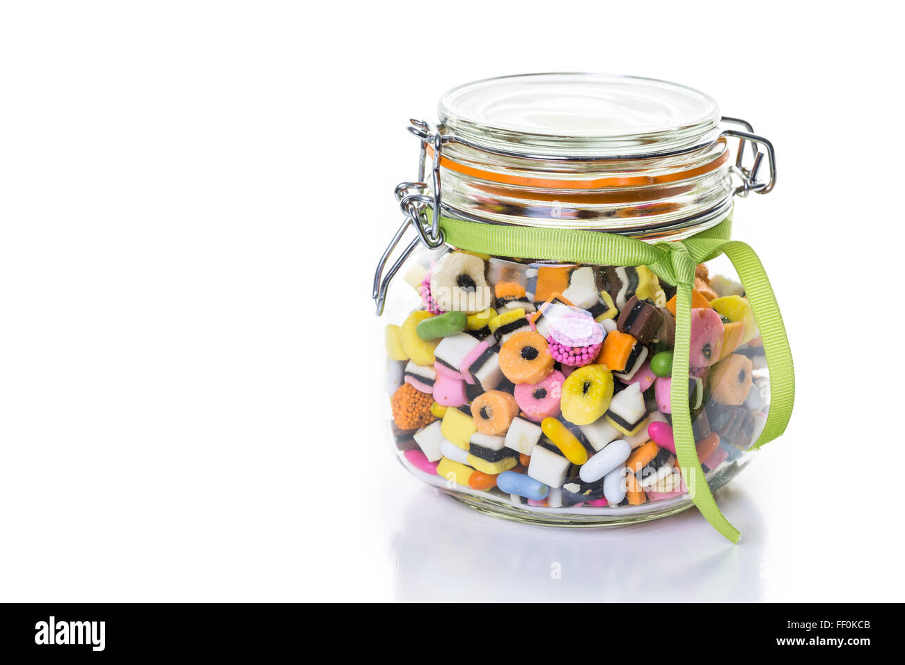 Colorful candies in glass candy jar on a white background Stock Photo ...