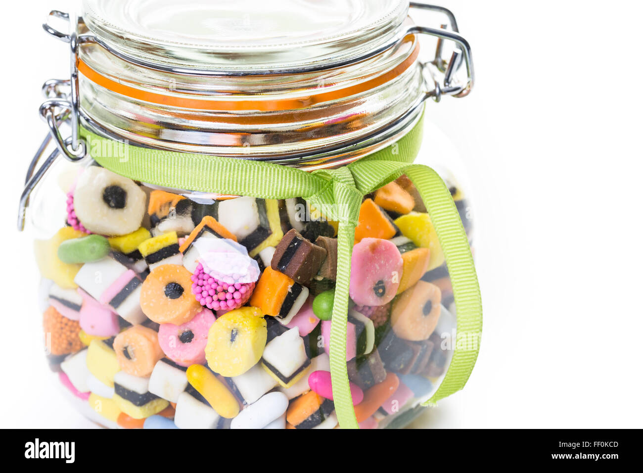 Colorful candies in glass candy jar on a white background Stock Photo ...
