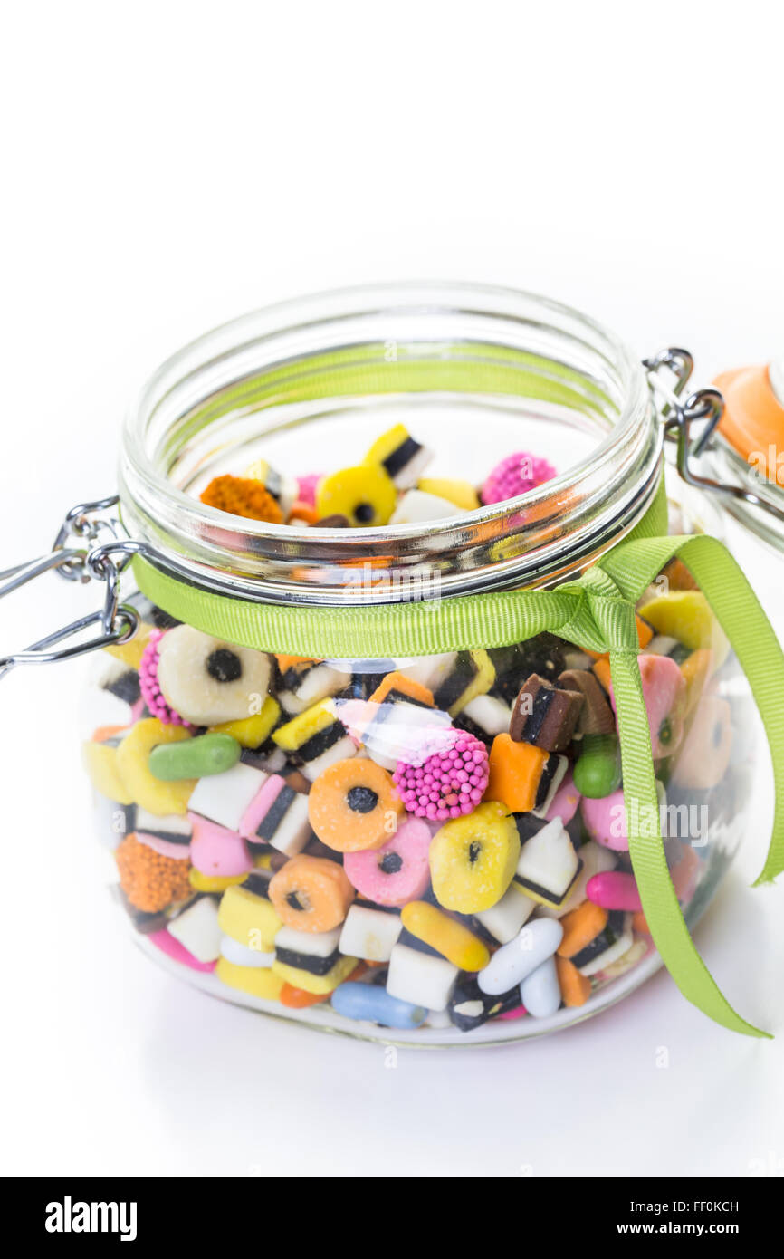Colorful candies in glass candy jar on a white background Stock Photo ...