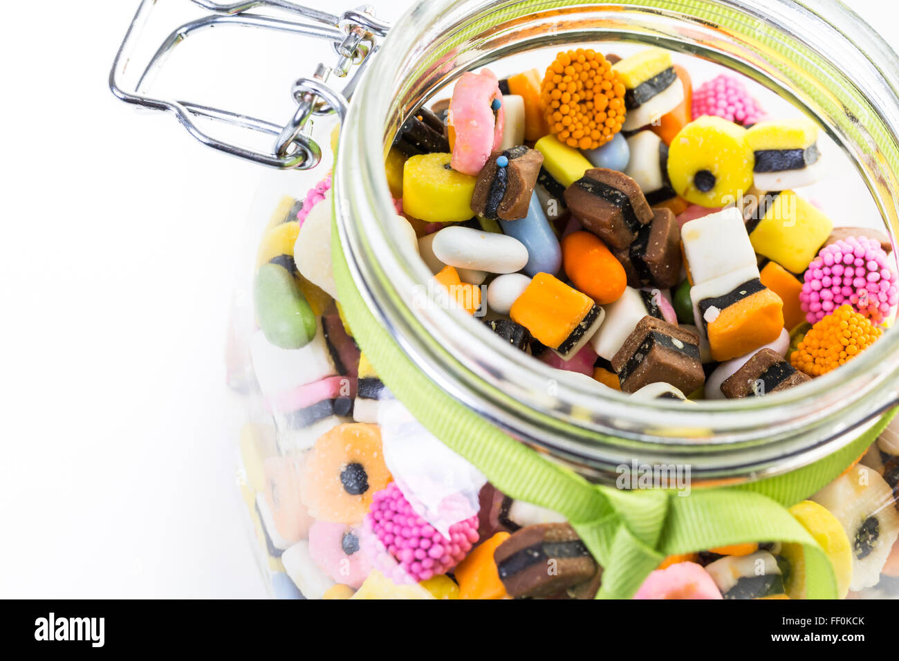 Colorful candies in glass candy jar on a white background Stock Photo ...