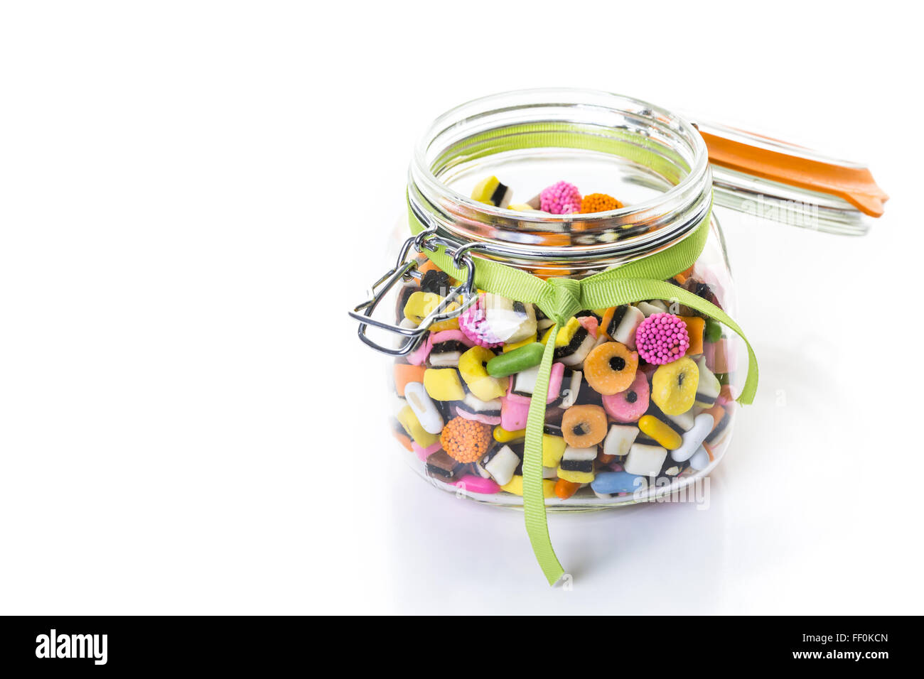Colorful candies in glass candy jar on a white background Stock Photo ...