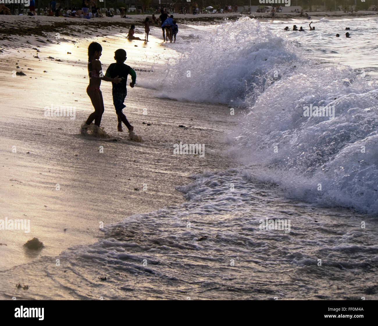 Children playing on beach at sunset hi-res stock photography and images ...