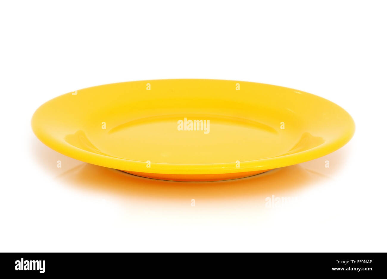 Empty yellow plate isolated on a white background Stock Photo - Alamy