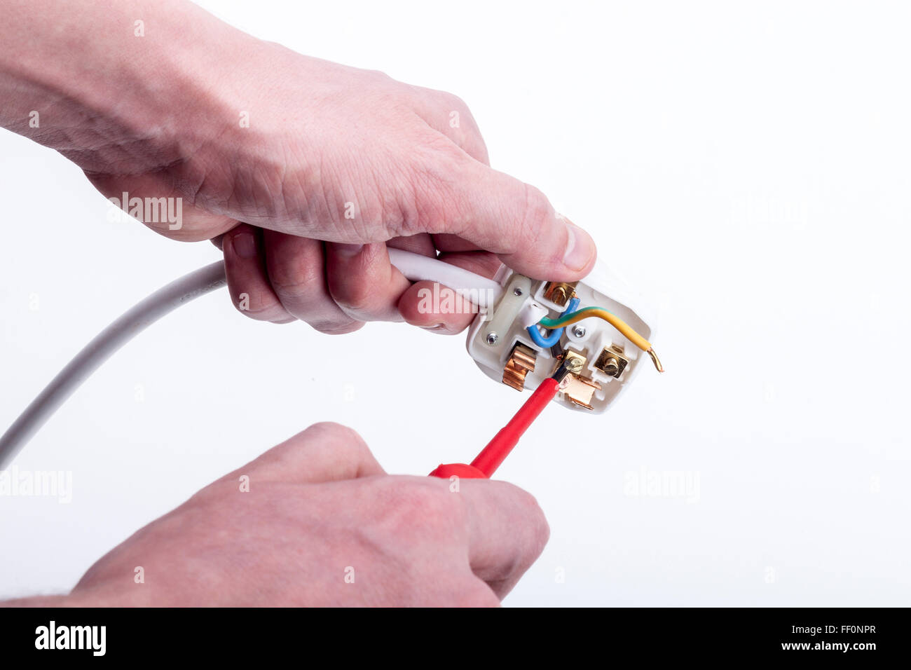 Electrical engineer fitting a flex to a uk 13A plug top Stock Photo - Alamy