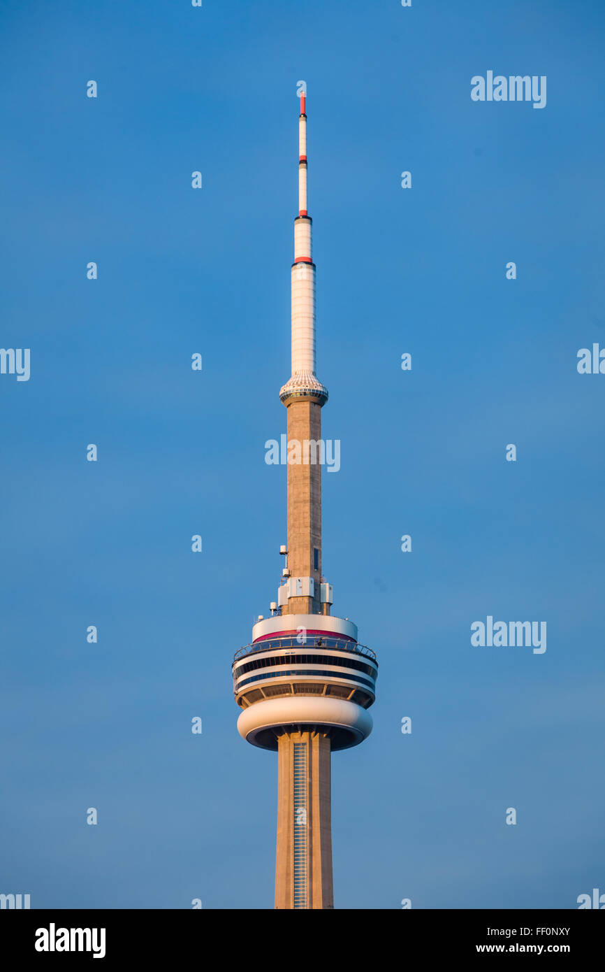 Very direct image of the CN Tower closeup against a plain blue sky ...